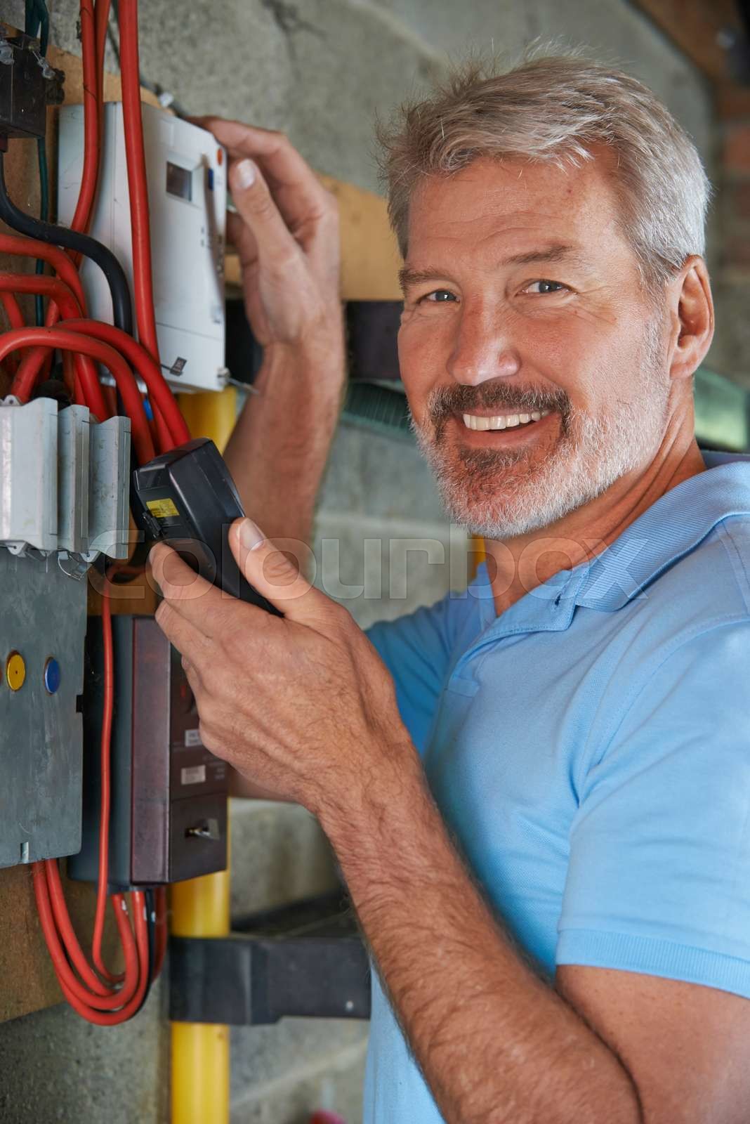 Portrait Of Man Taking Electricity Meter Reading | Stock image | Colourbox