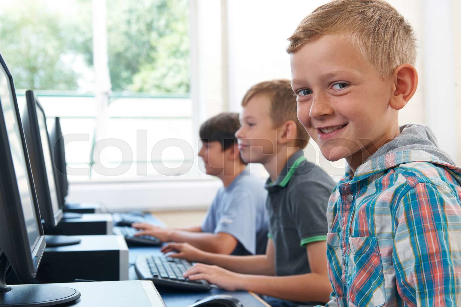Group Of Male Elementary School Children In Computer Class | Stock ...