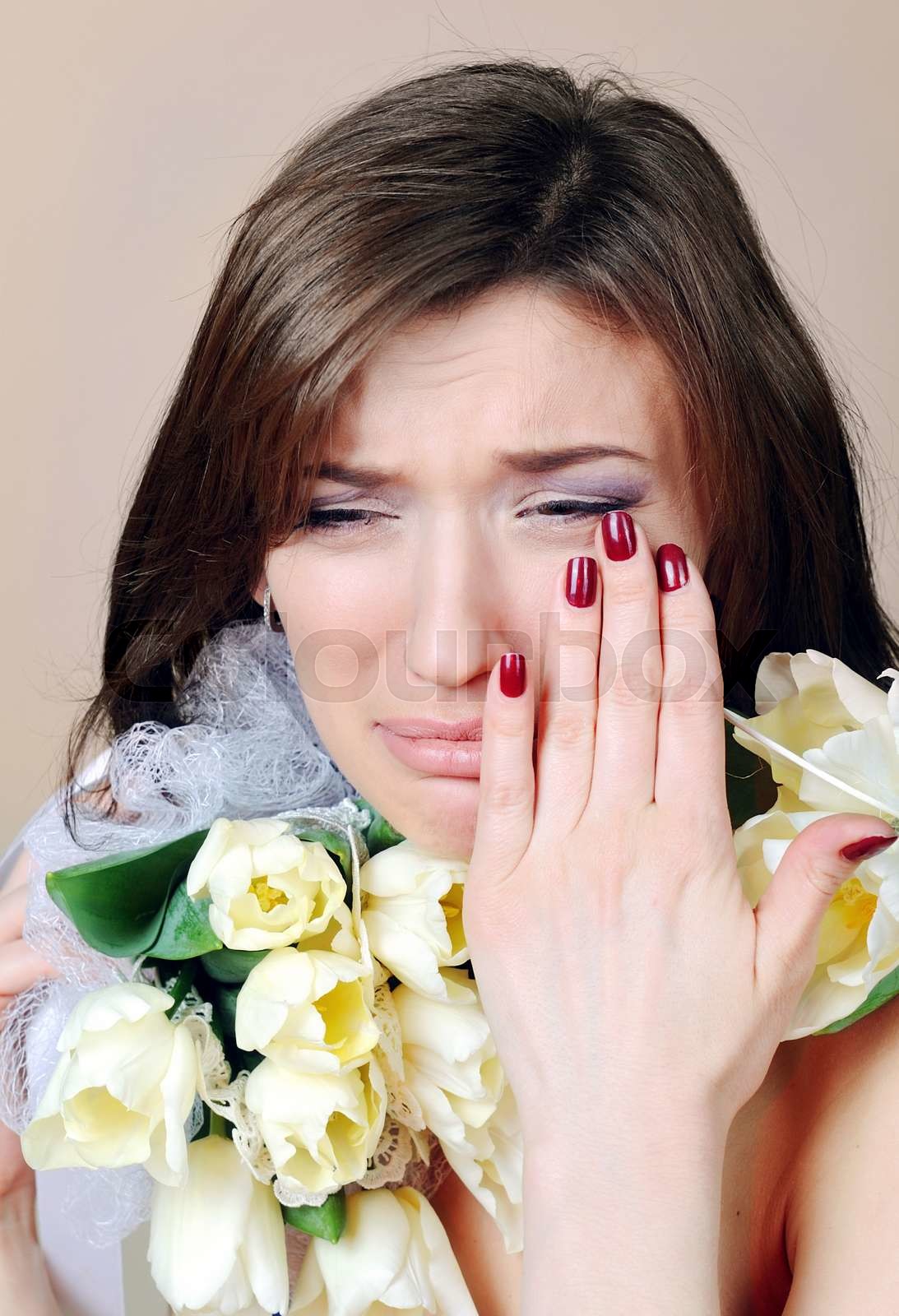 crying woman with white flowers tulips | Stock image | Colourbox