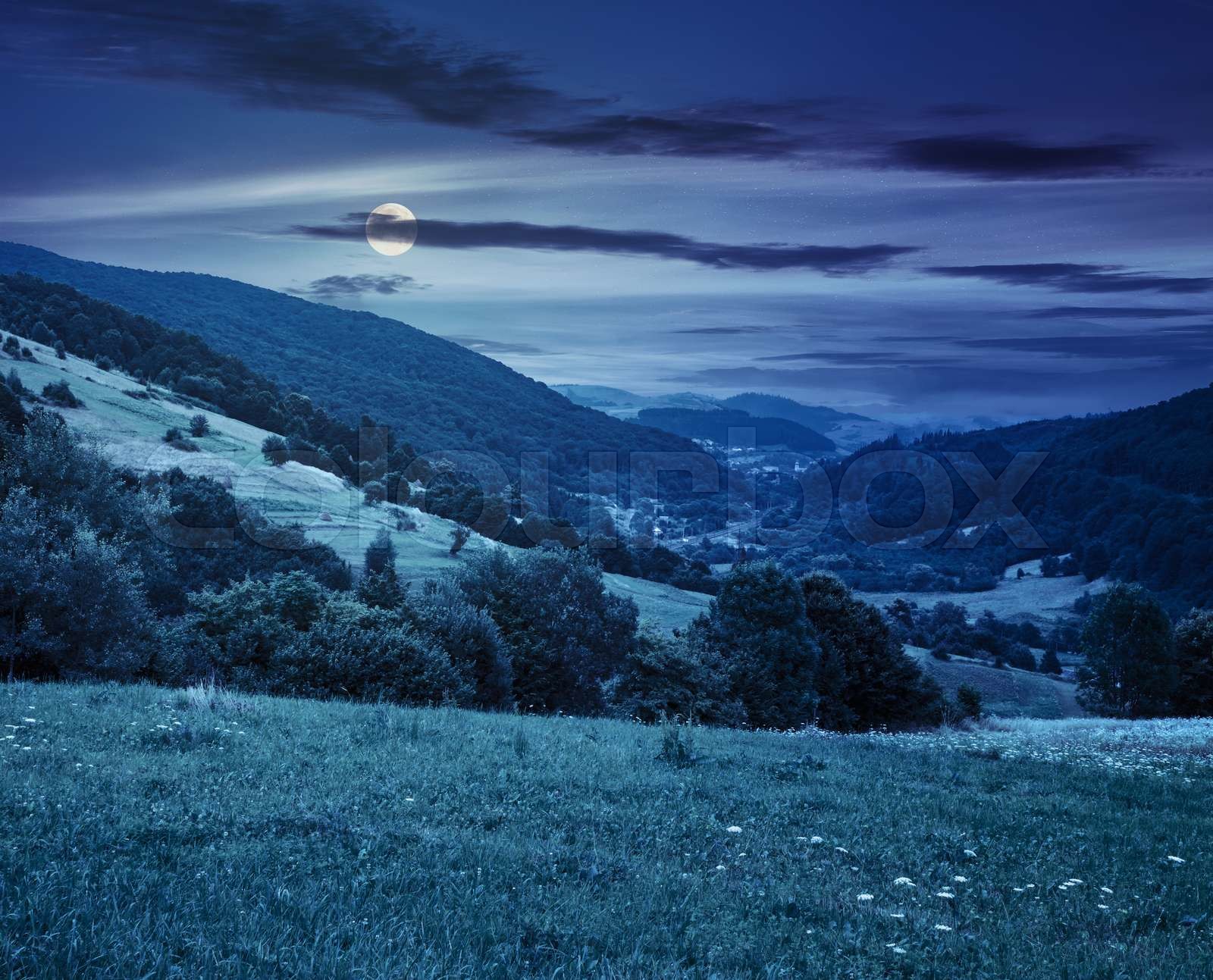village on hillside meadow at night | Stock image | Colourbox