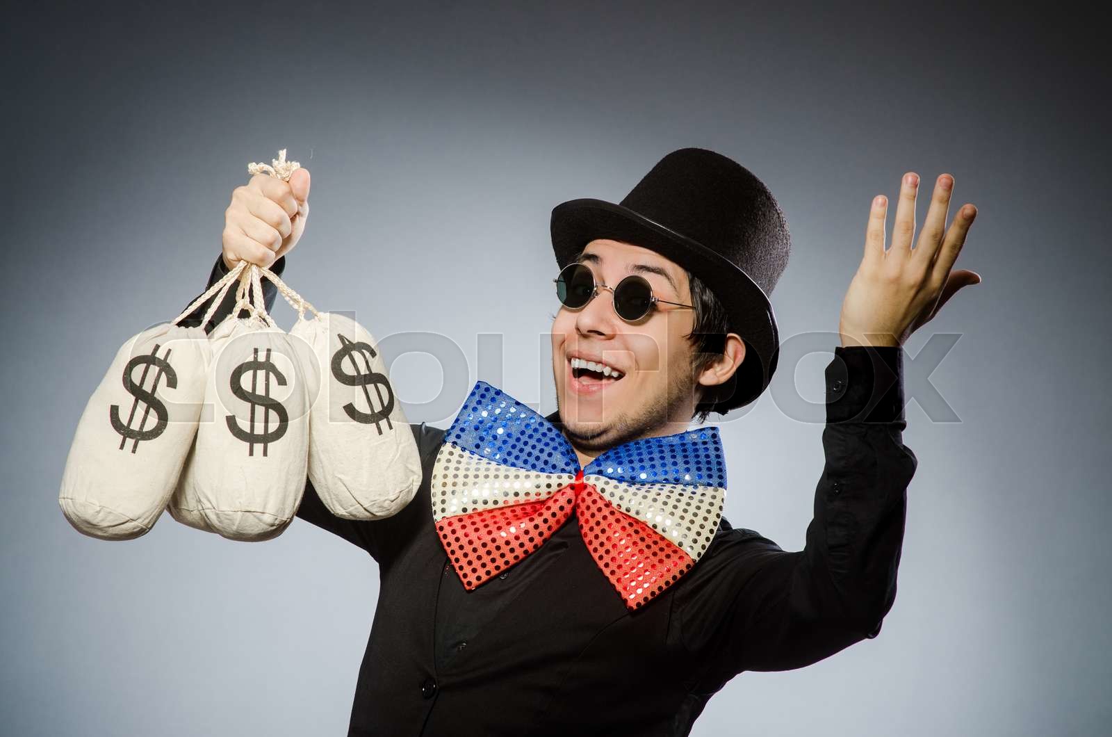 Funny man with money dollar sacks | Stock image | Colourbox