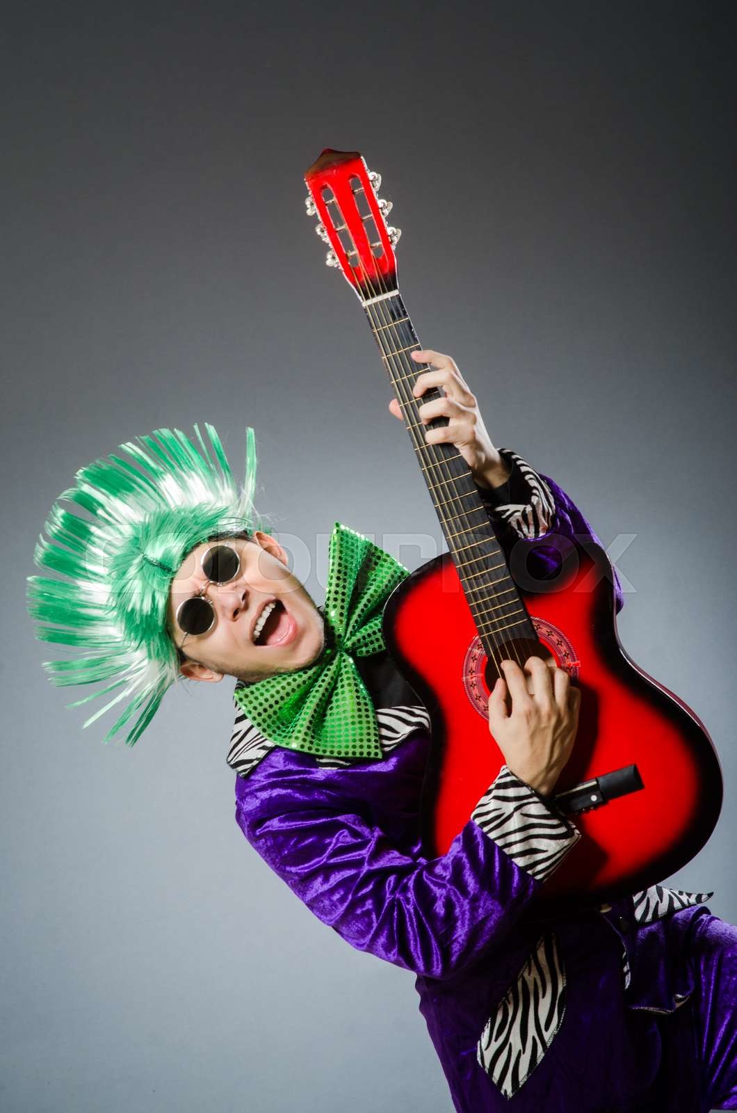 Funny man playing guitar in musical concept | Stock image | Colourbox