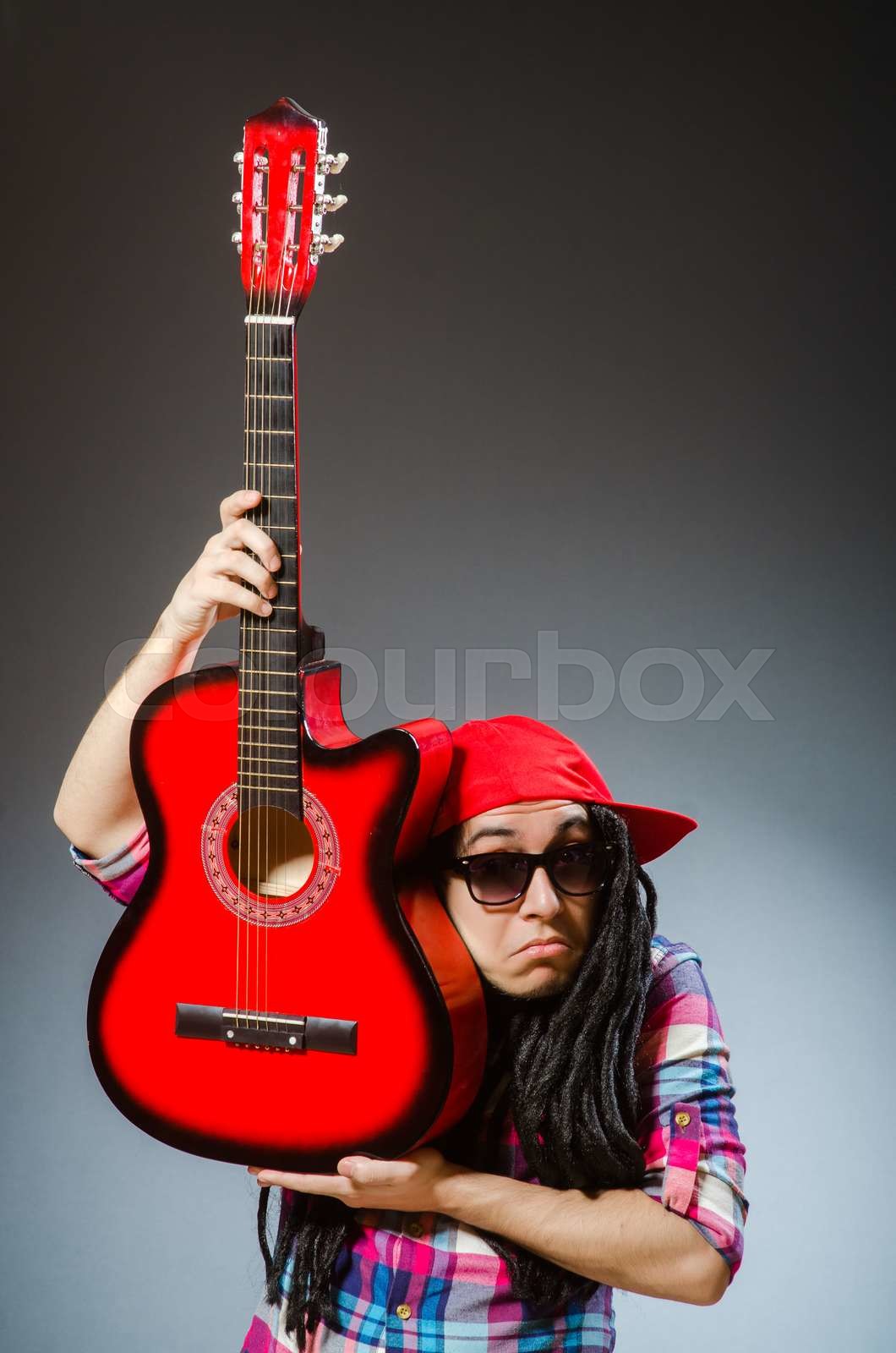 Funny man playing guitar in musical concept | Stock image | Colourbox