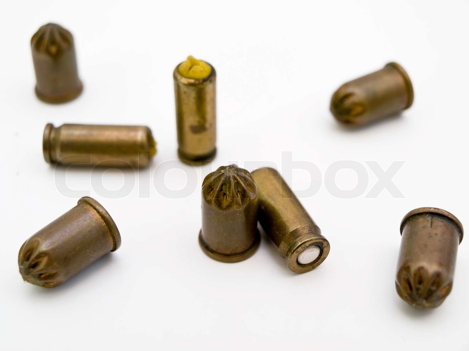 scattered metal bullets at the white table | Stock image | Colourbox