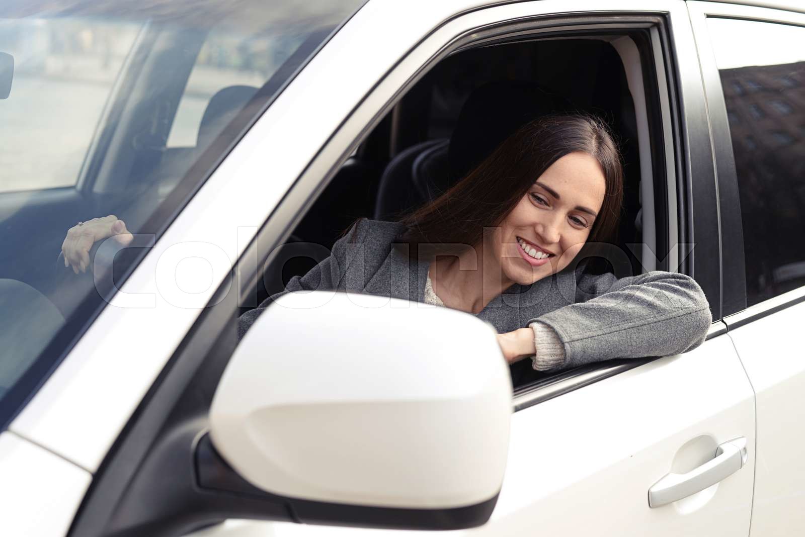woman driving a car and looking at rearview mirror | Stock image ...