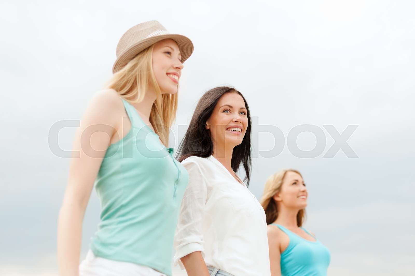 group of smiling girls chilling on the beach | Stock image | Colourbox