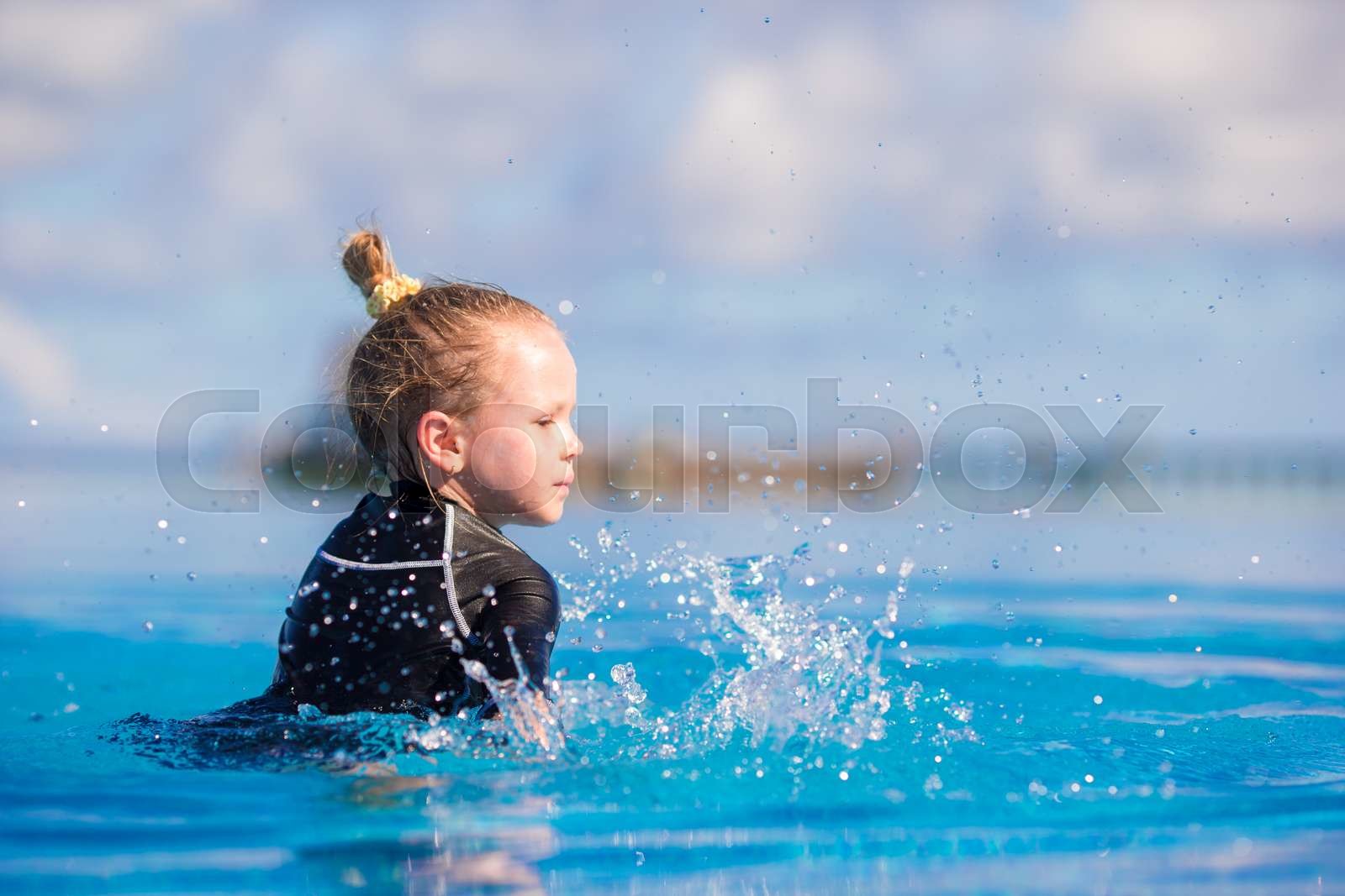 Little happy adorable girl in outdoor swimming pool | Stock image ...