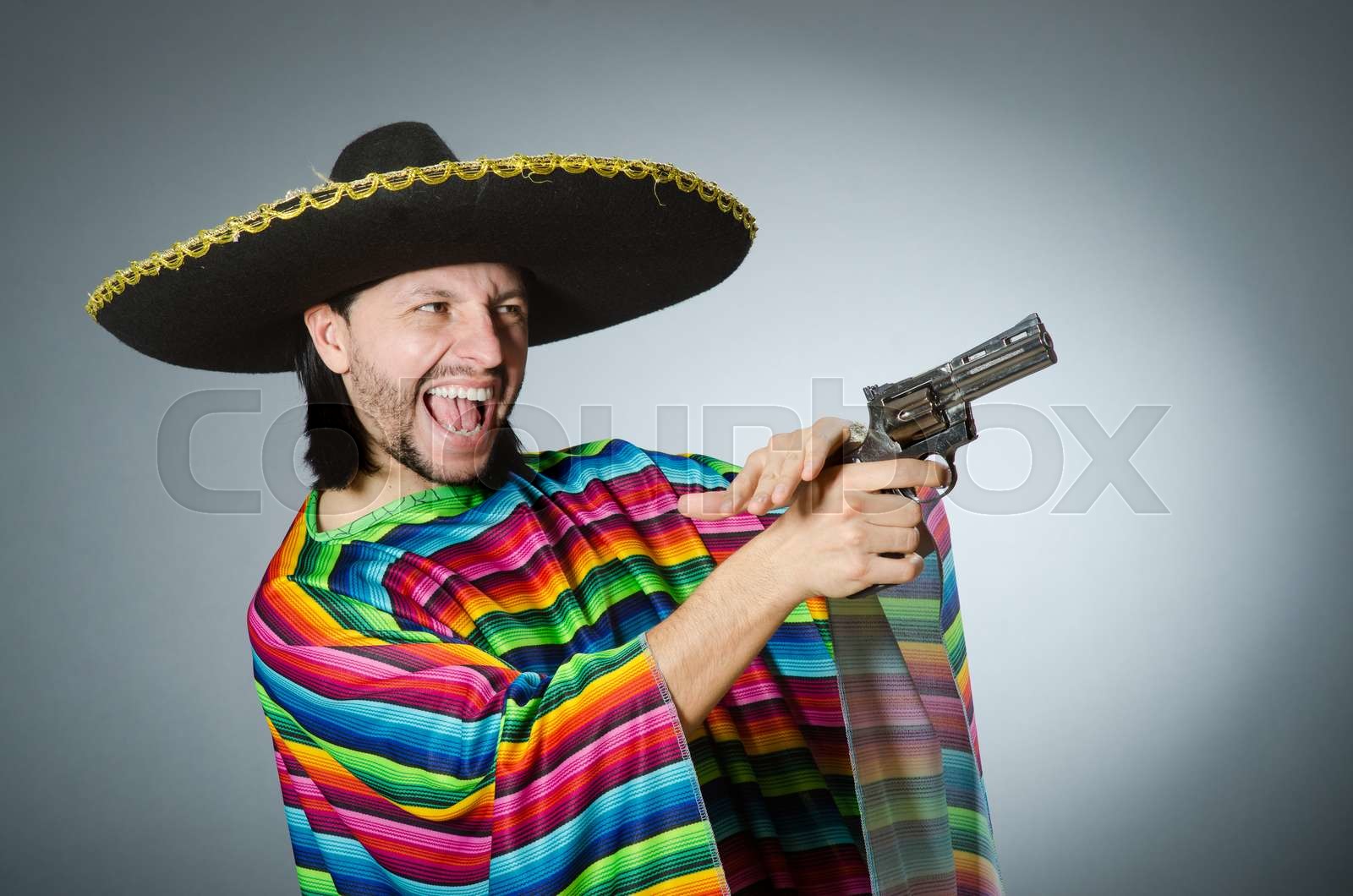 Mexican with gun wearing sombrero | Stock image | Colourbox