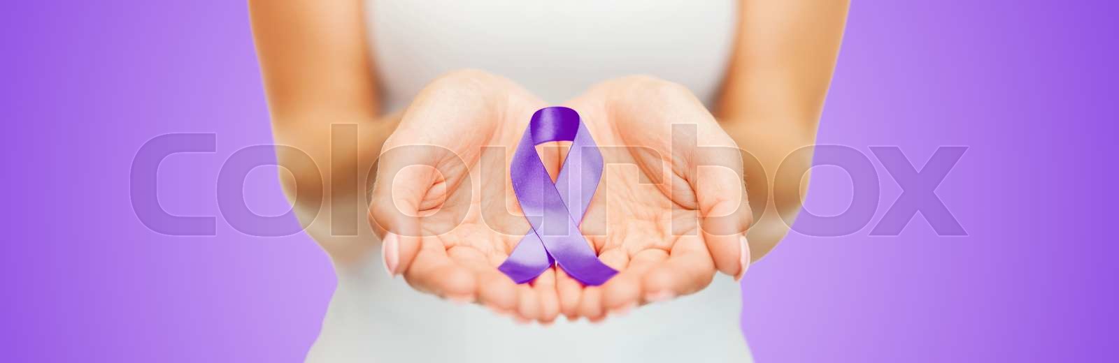 close up of hands holding purple awareness ribbon | Stock image | Colourbox