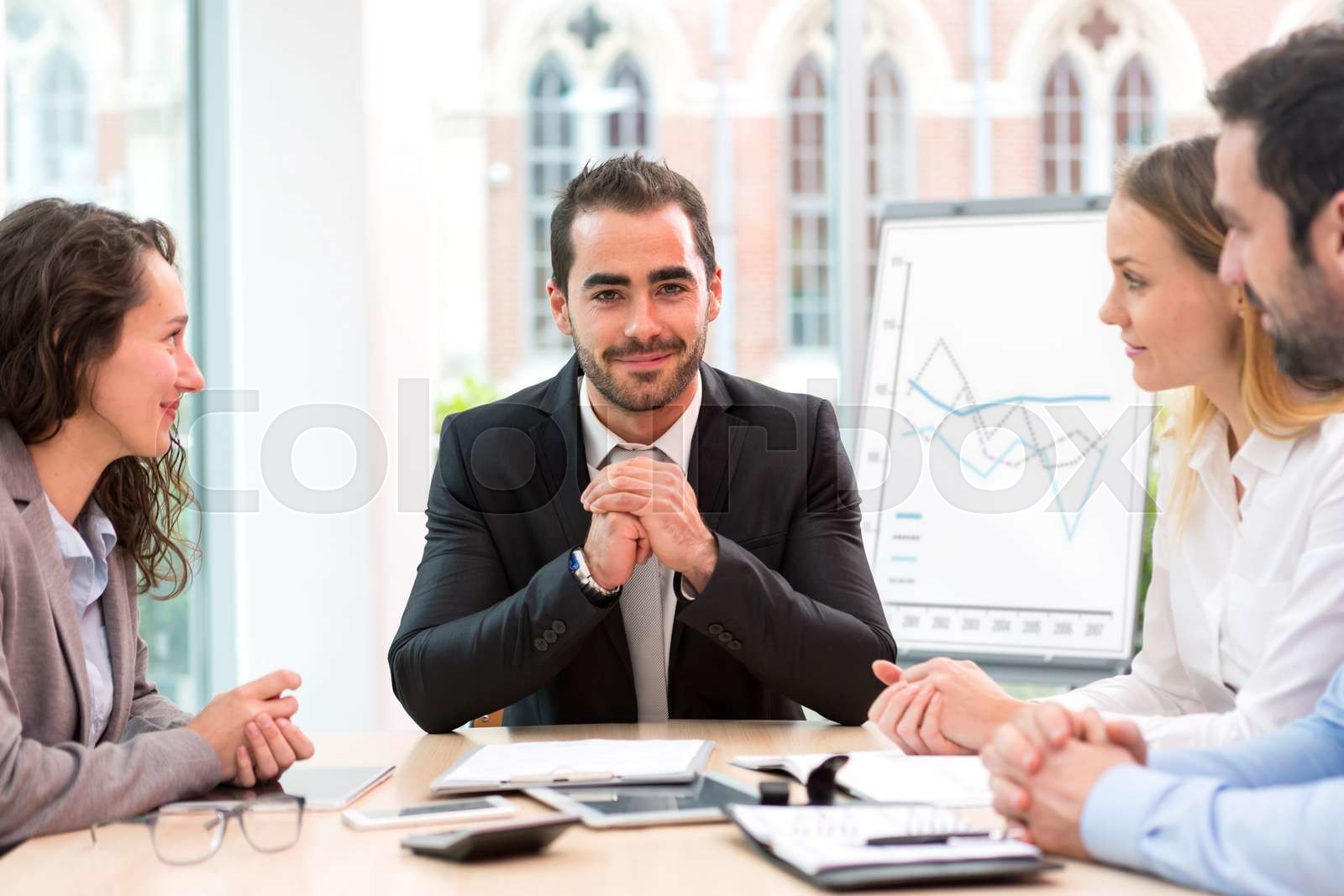 Boss heading a business reunion with partners | Stock image | Colourbox