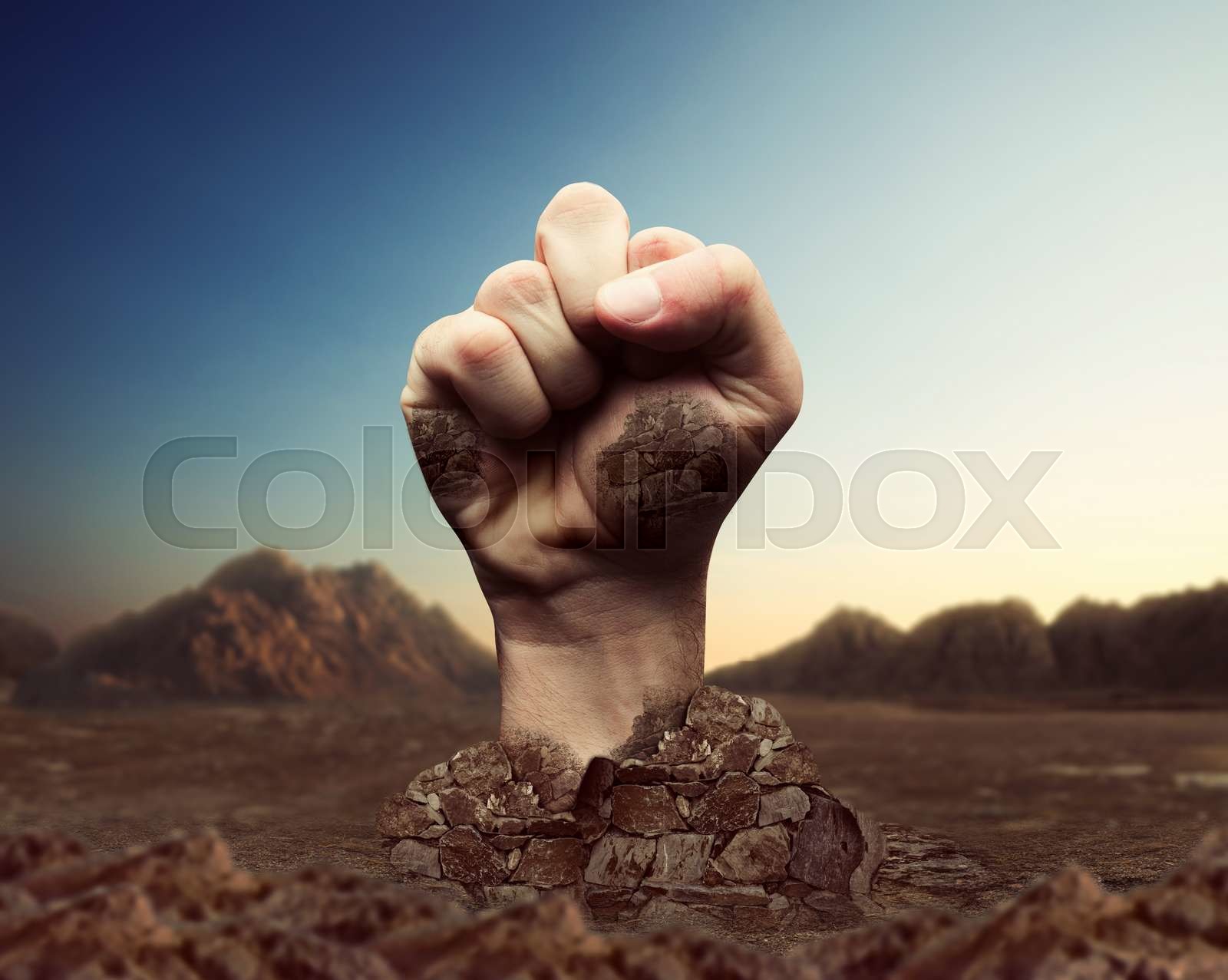 Human fist bursts through the ground | Stock image | Colourbox