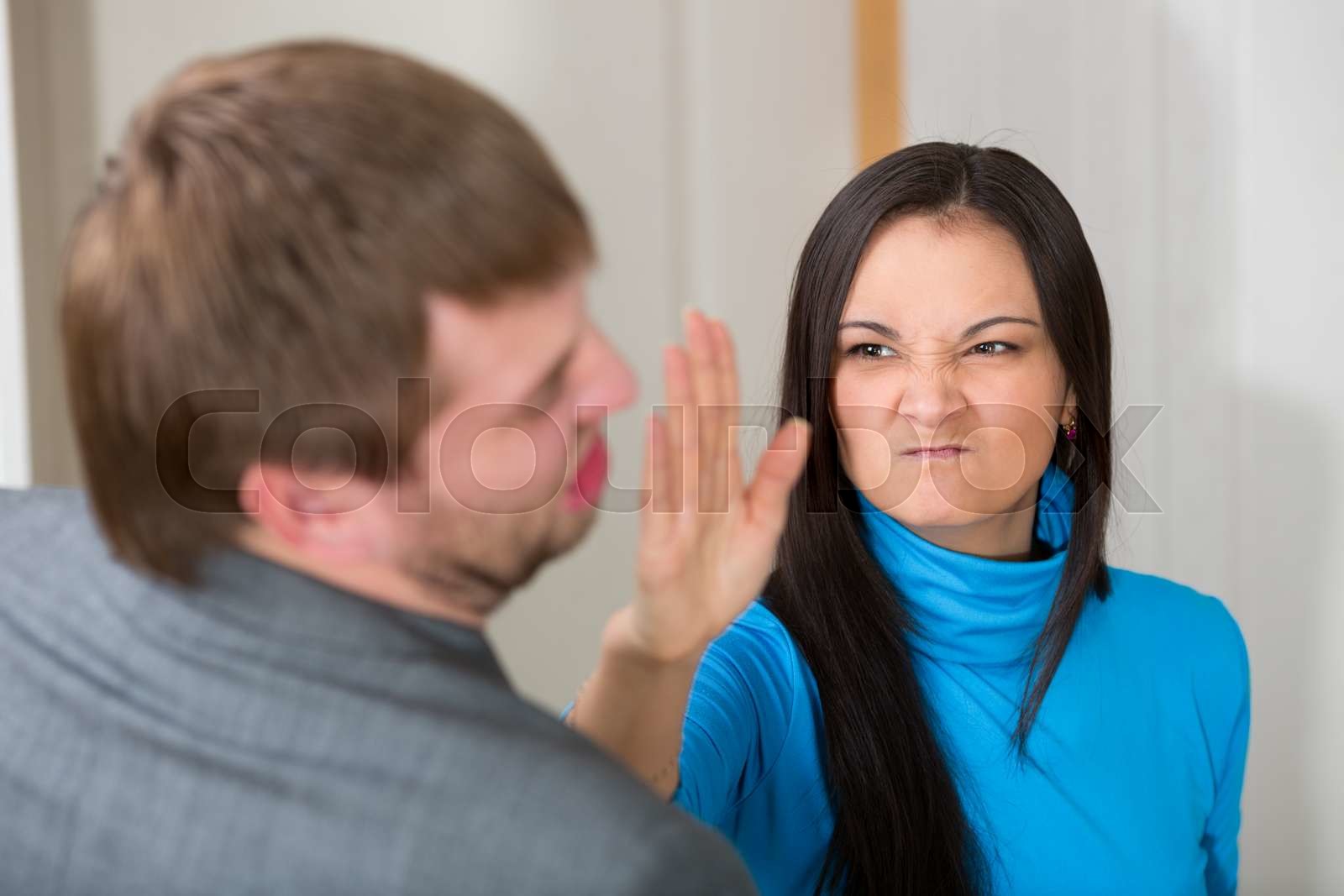 Woman about to slap her partner | Stock image | Colourbox