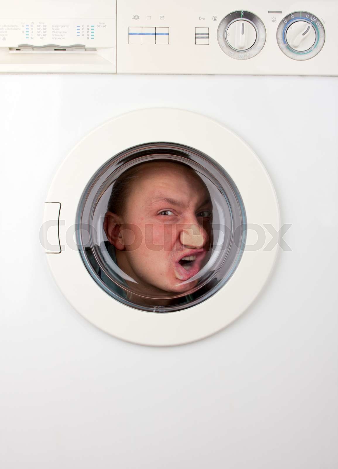 Bizarre man inside washing machine | Stock image | Colourbox