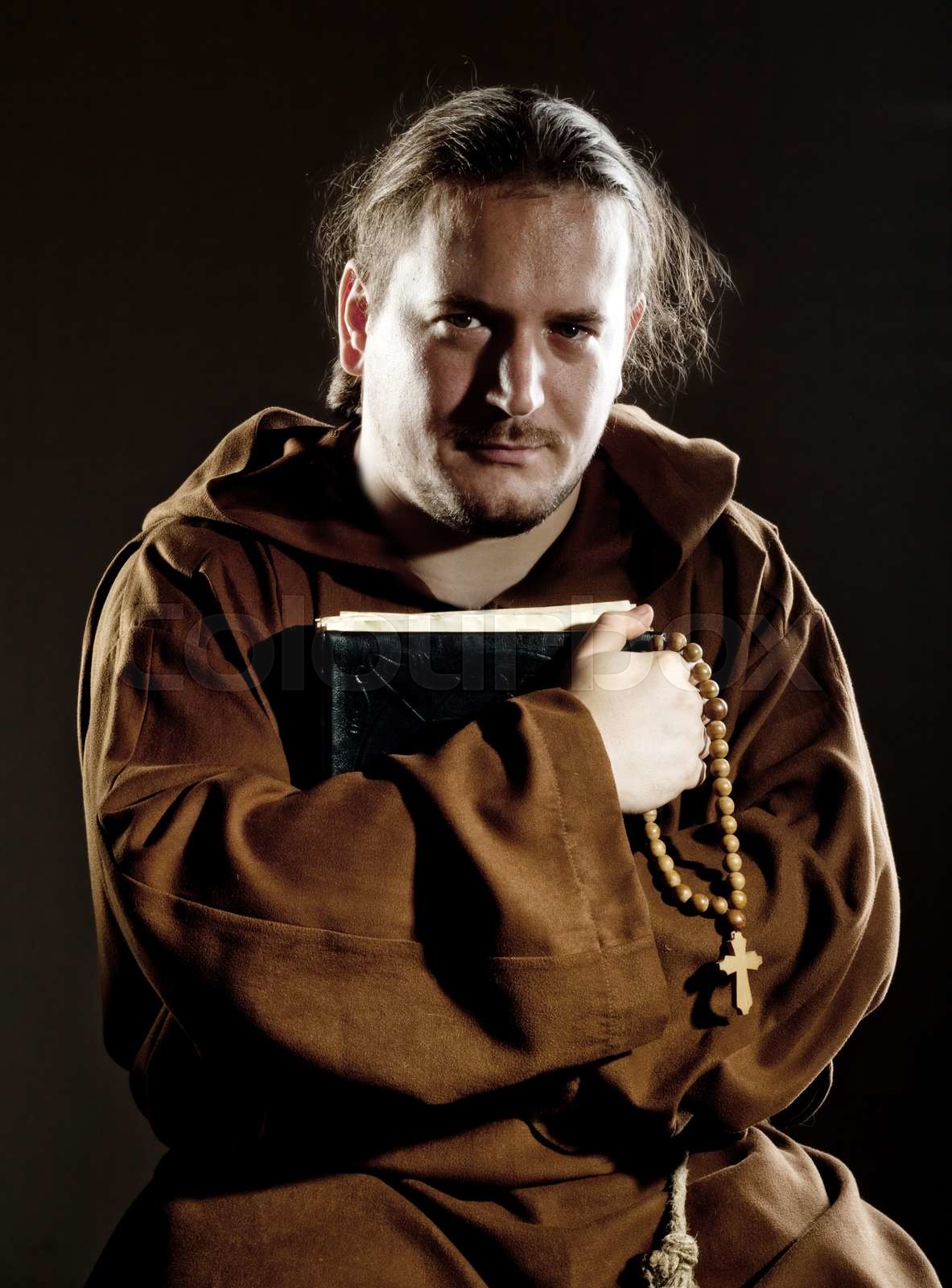 Monk with bible and rosary | Stock image | Colourbox