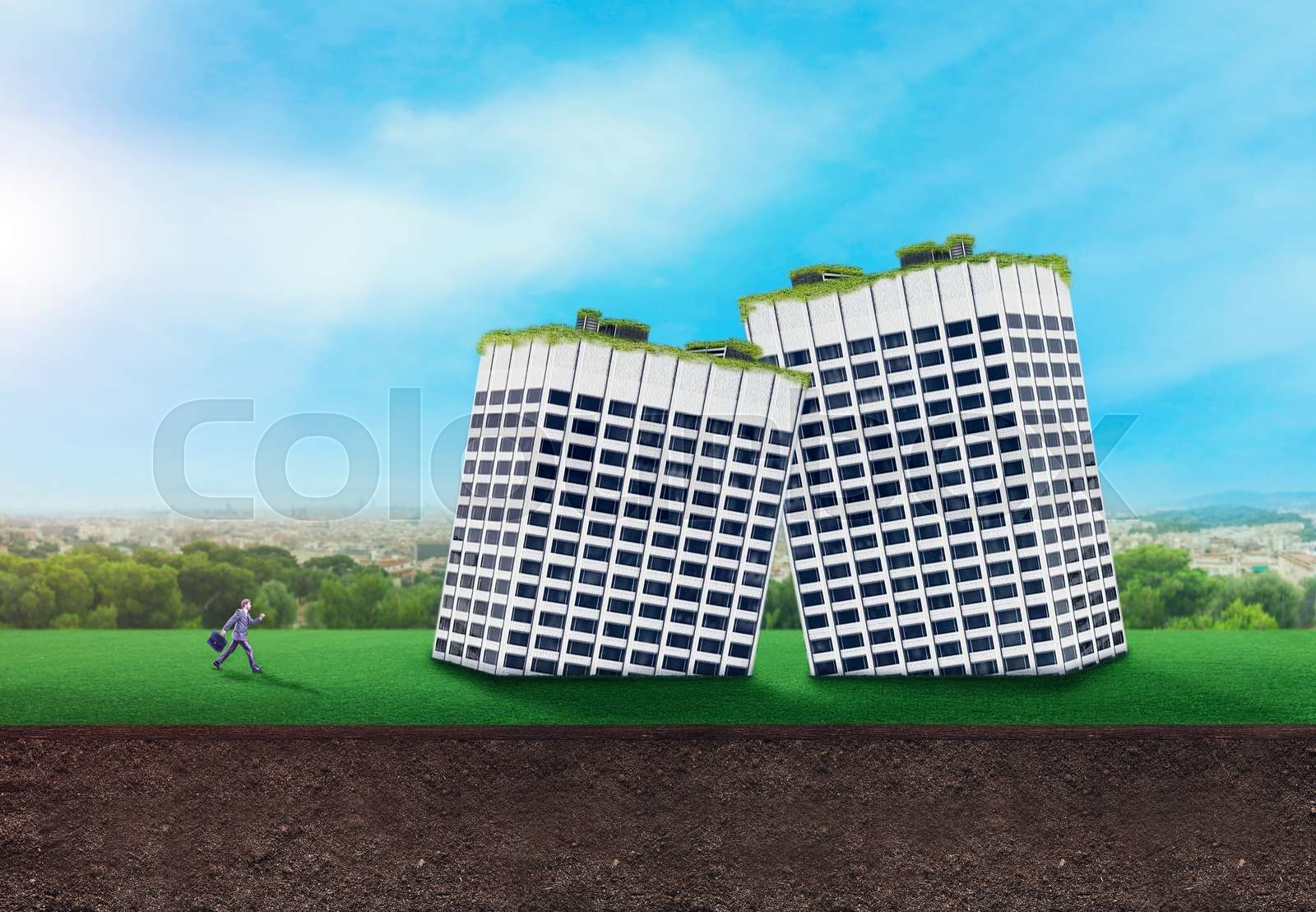 Businessman and falling buildings | Stock image | Colourbox