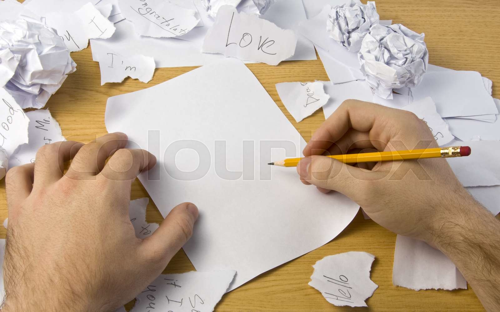 Workspace with crushed paper and hands | Stock image | Colourbox