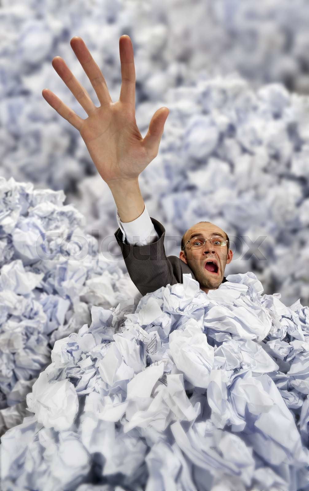 Businessman sinking in big heap of crumpled papers | Stock image ...