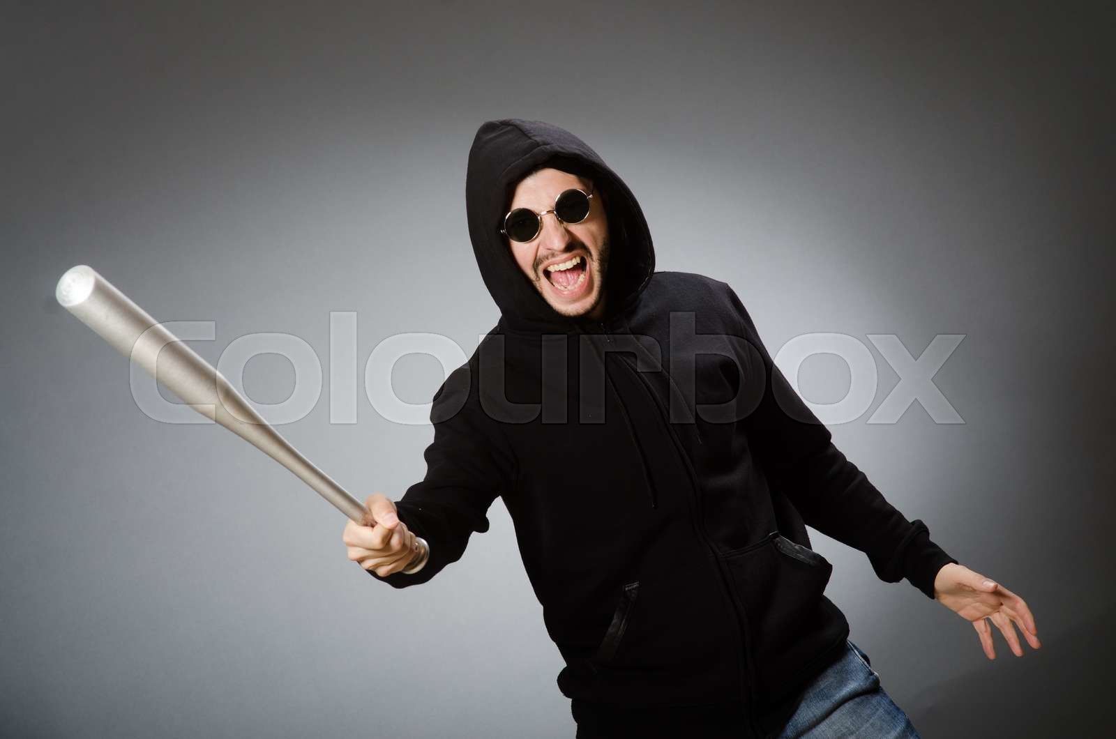 Aggressive man with basebal bat | Stock image | Colourbox