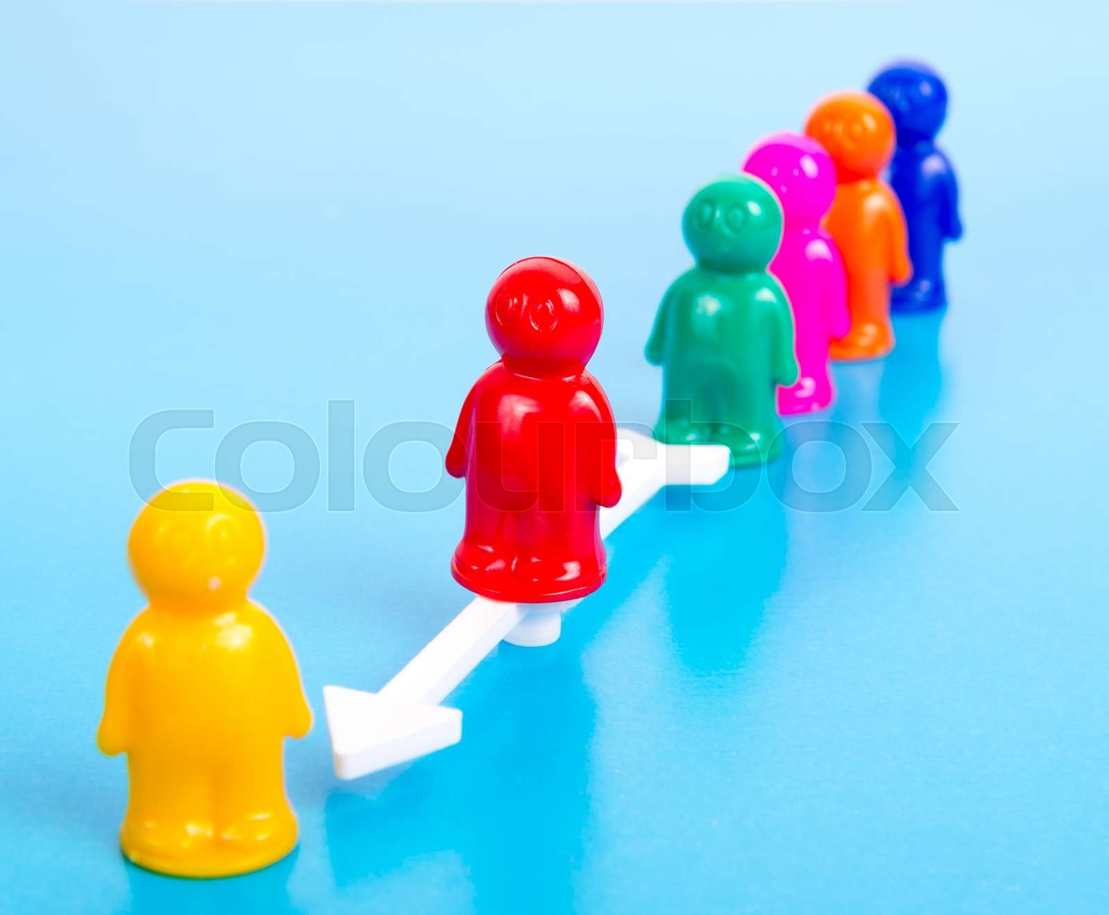 group of toy people and direction arrow | Stock image | Colourbox