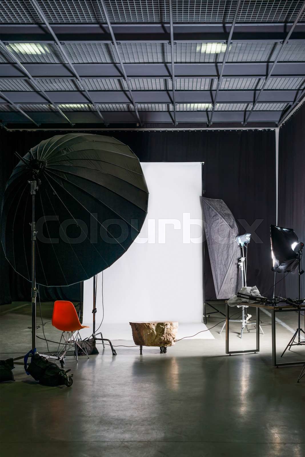 Empty photo studio with modern interior and lighting equipment ...