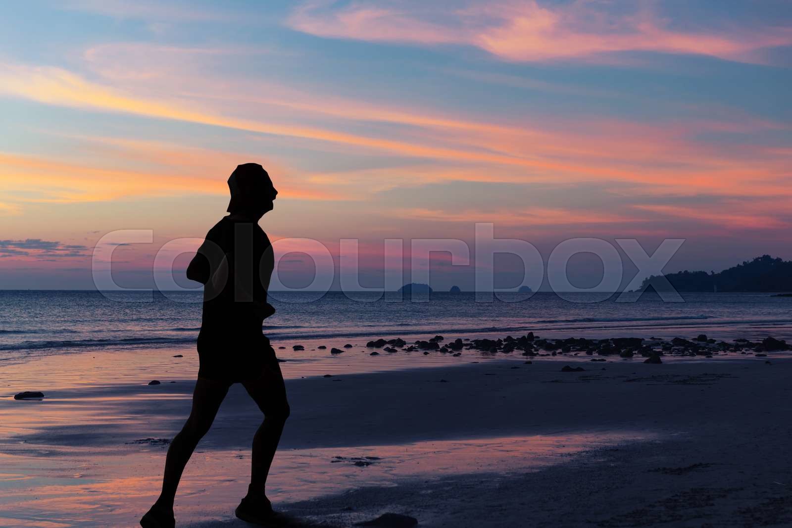 Woman walk along the sea coast | Stock image | Colourbox