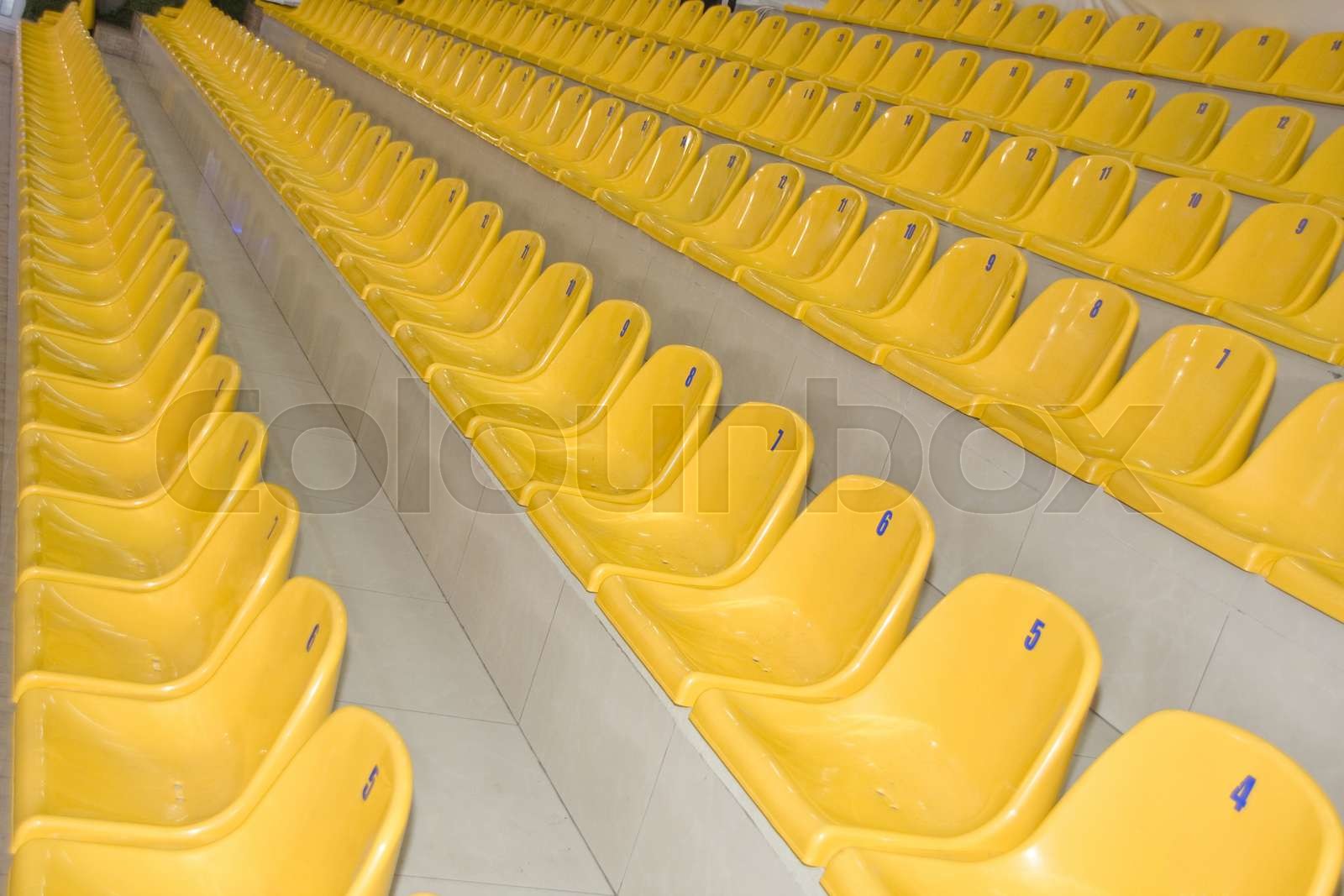 Rows of yellow seats | Stock image | Colourbox
