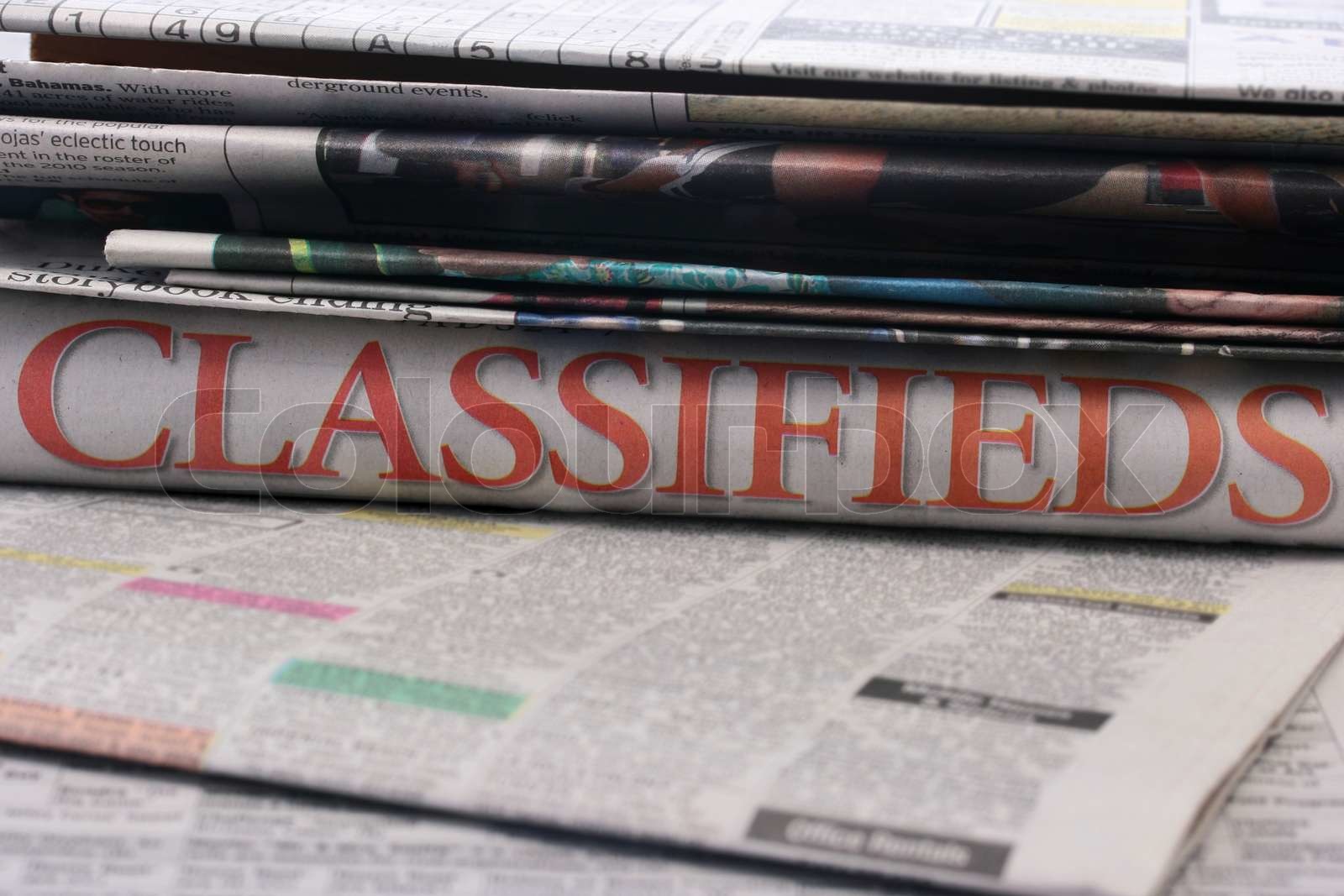 The newspaper classifieds among newspapers combined by a pile. | Stock ...