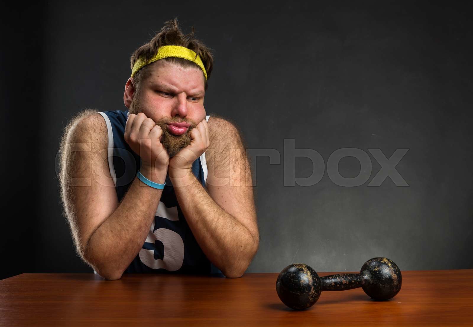 Sad man with a dumbbell | Stock image | Colourbox