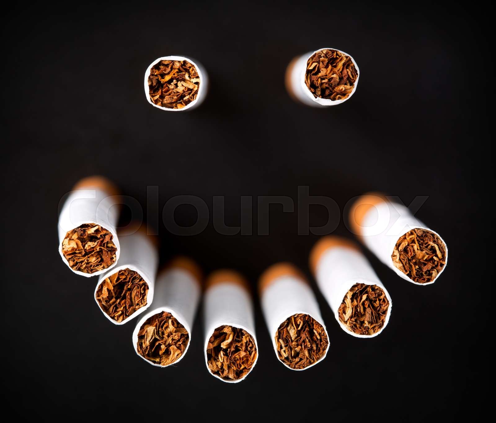 Smiley face made of cigarettes | Stock image | Colourbox