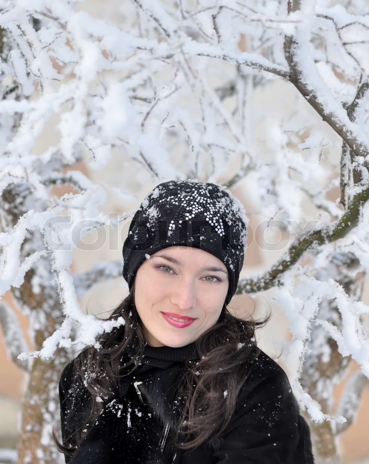 portrait of a pretty young brunette girl outdoor on a warm winter day ...