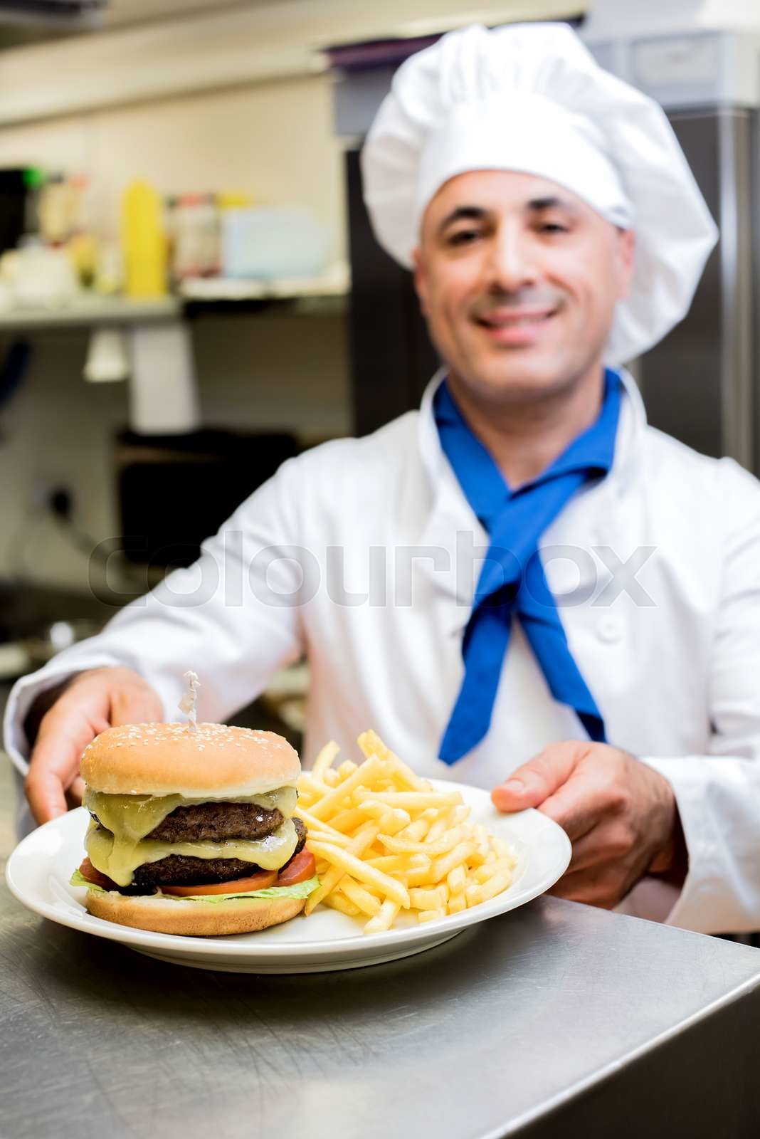 Male chef serving the order | Stock image | Colourbox