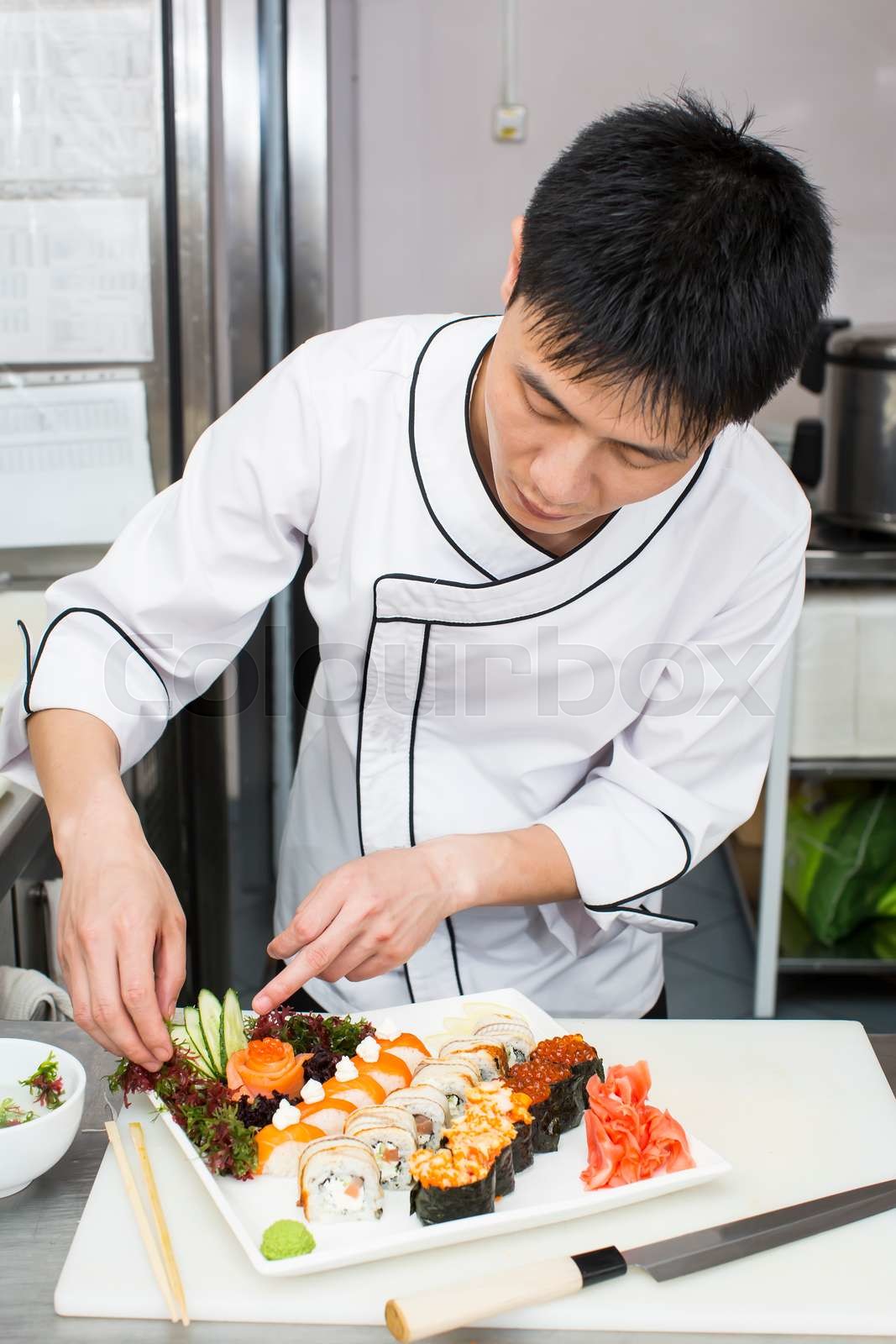 Japanese chef preparing a meal in a restaurant | Stock image | Colourbox