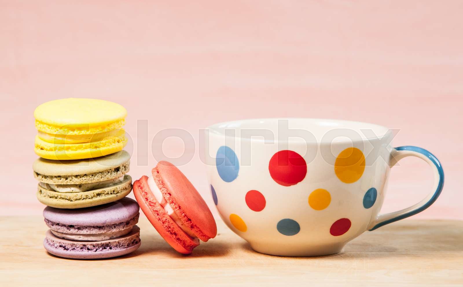 French macarons and cup on table | Stock image | Colourbox