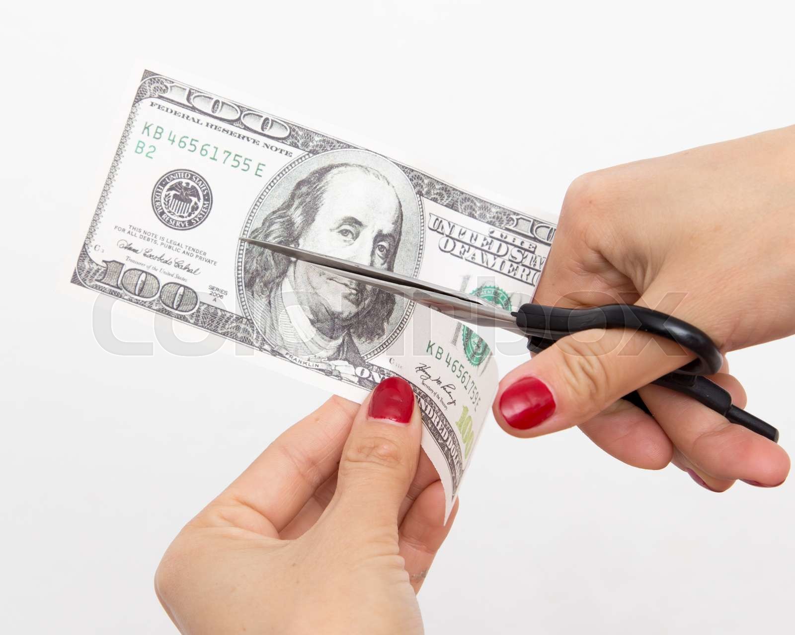 100 dollar cut with scissors on white | Stock image | Colourbox
