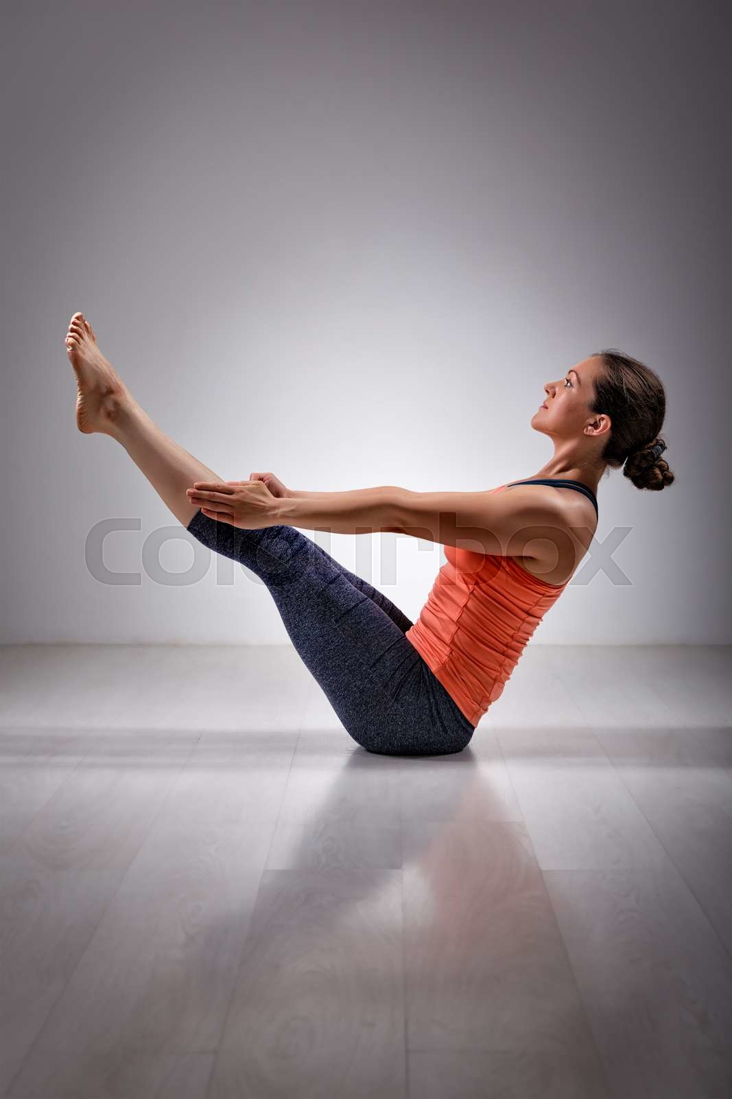 Woman practices yoga asana Paripurna navasana | Stock image | Colourbox