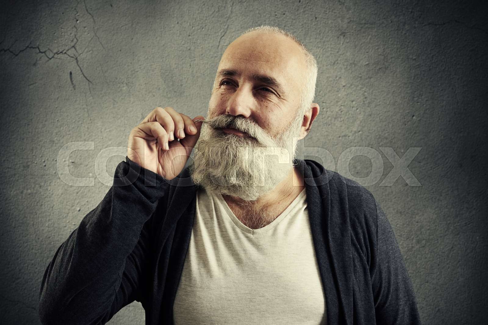 smiley senior man twisting his mustache | Stock image | Colourbox