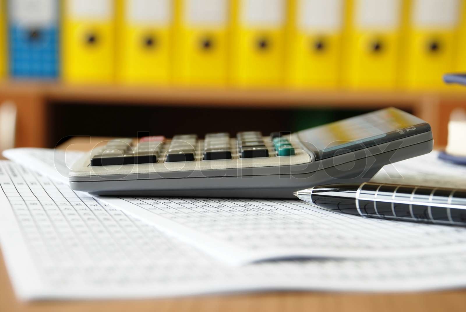 calculator on office desk side view, pen and papers | Stock image ...
