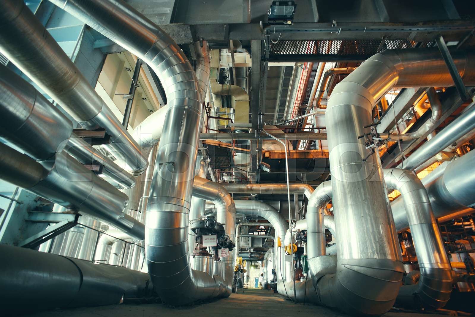 different size and shaped pipes and valves at a power plant | Stock ...