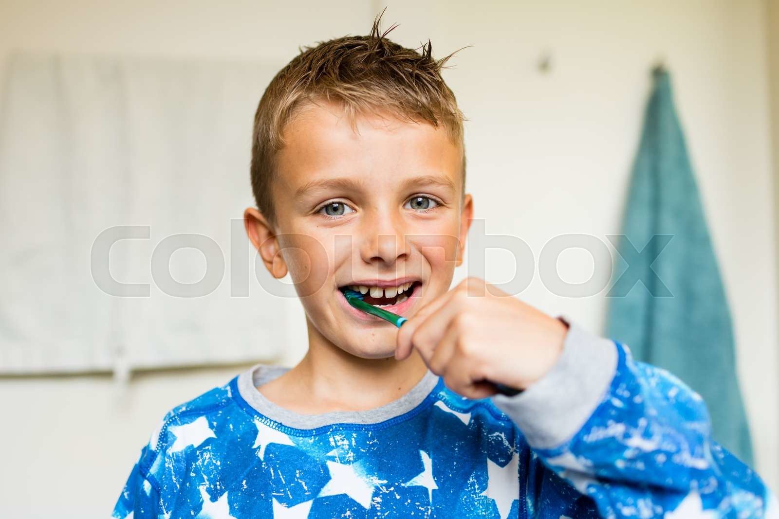 Young child brushing teeth with toothbrush | Stock image | Colourbox