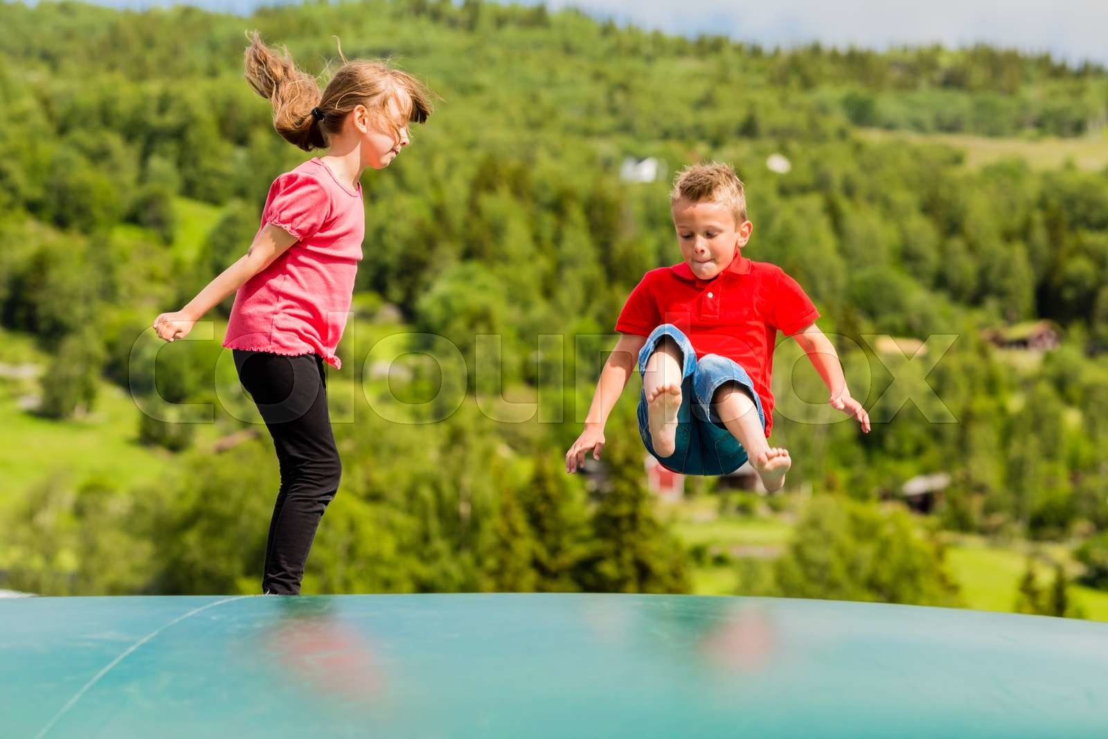 Children bouncing up and down on trampoline | Stock image | Colourbox