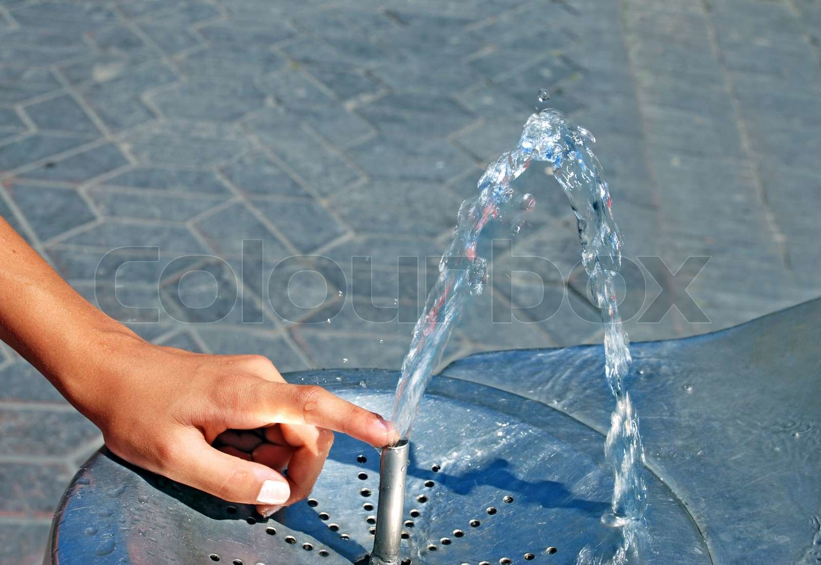Water drinking fountain with human hand close up | Stock image | Colourbox
