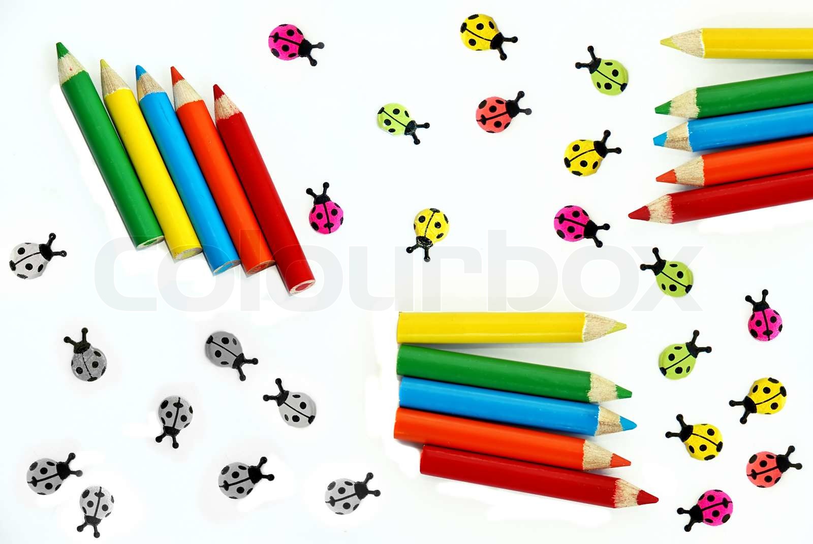 various small crayons and ladybirds isolated over white | Stock image ...