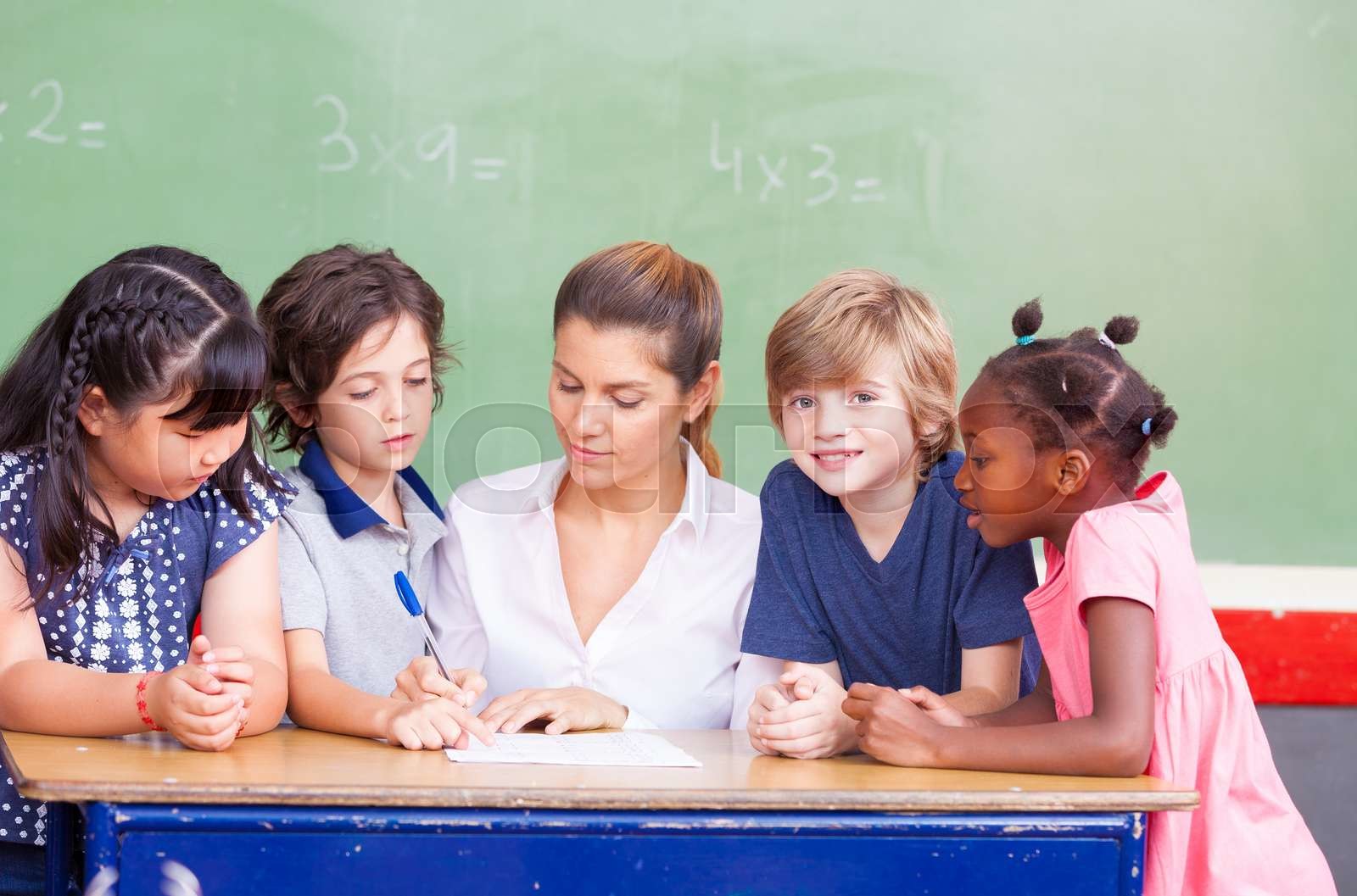 Happy children in a multi ethnic elementary classroom | Stock image ...