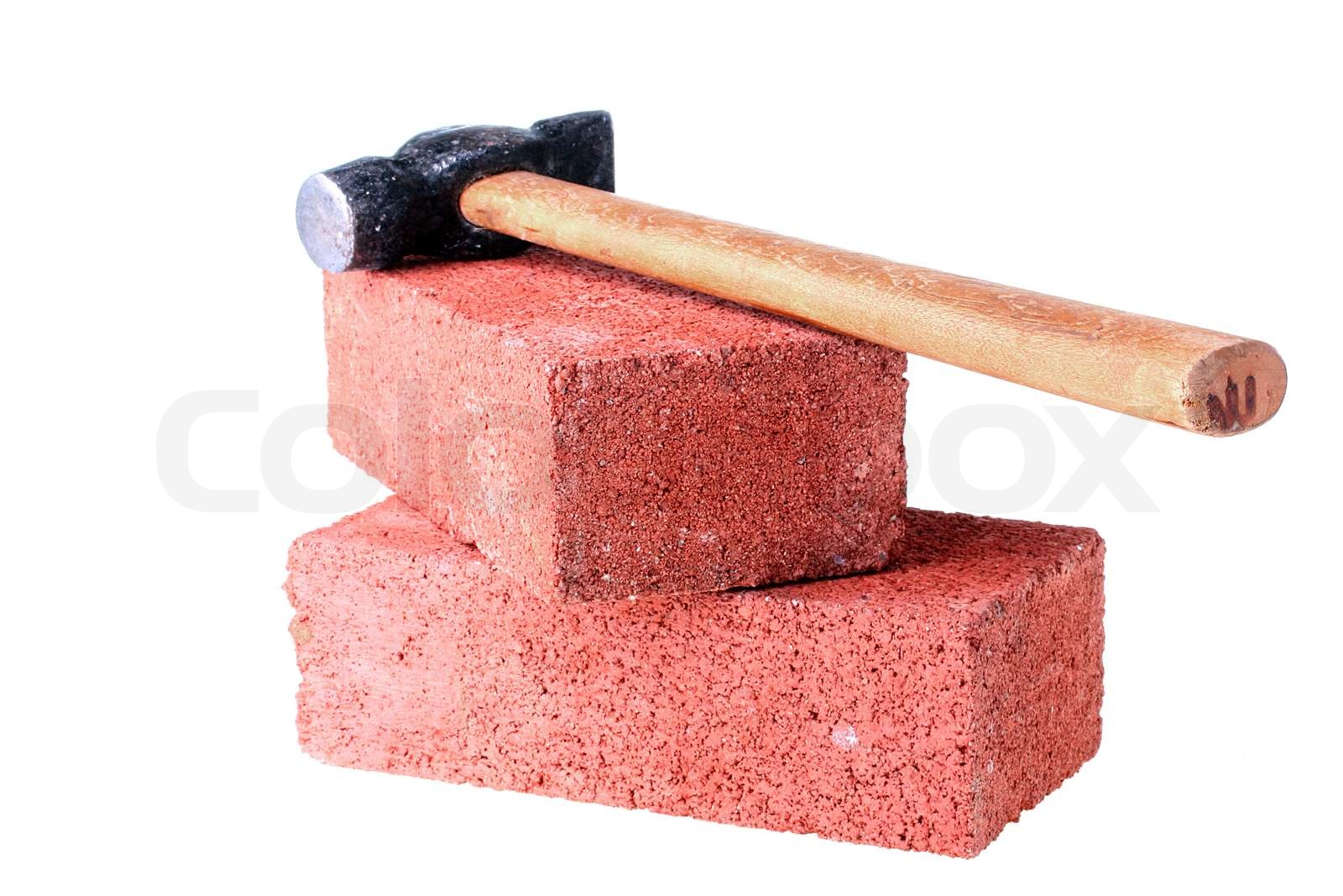Building materials and tools: a hammer with a brick from red clay ...