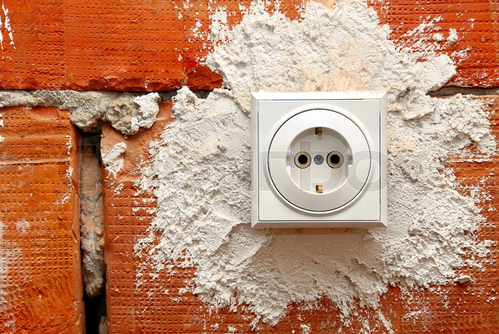 electrical jack installed on red brick wall | Stock image | Colourbox