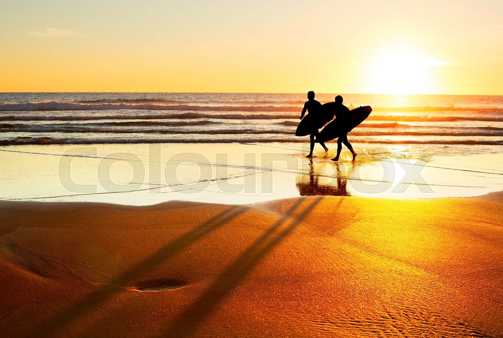 Surfers on the beach | Stock image | Colourbox