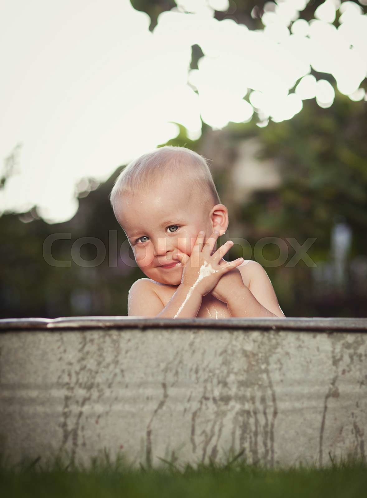 Little boy bathing outside | Stock image | Colourbox