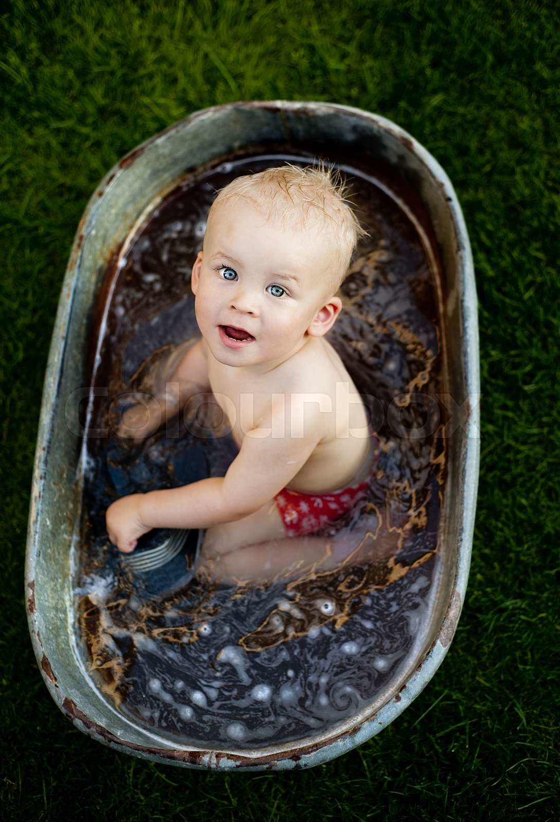 Little boy bathing outside | Stock image | Colourbox