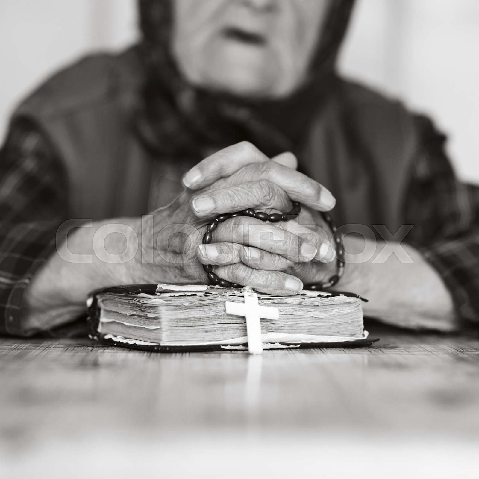 Old woman praying | Stock image | Colourbox