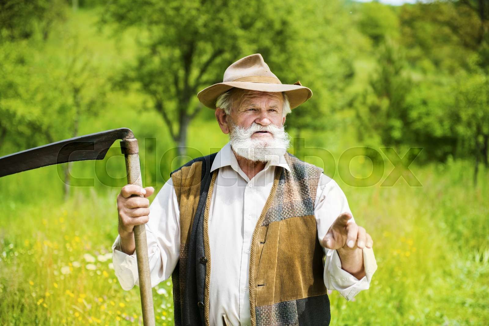 Man with scythe | Stock image | Colourbox
